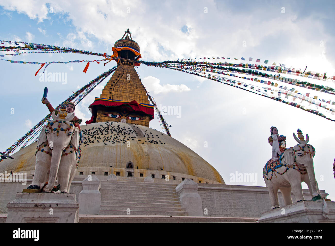 Back lit Bodhnath Stupa Temple and statues with overcast day ...