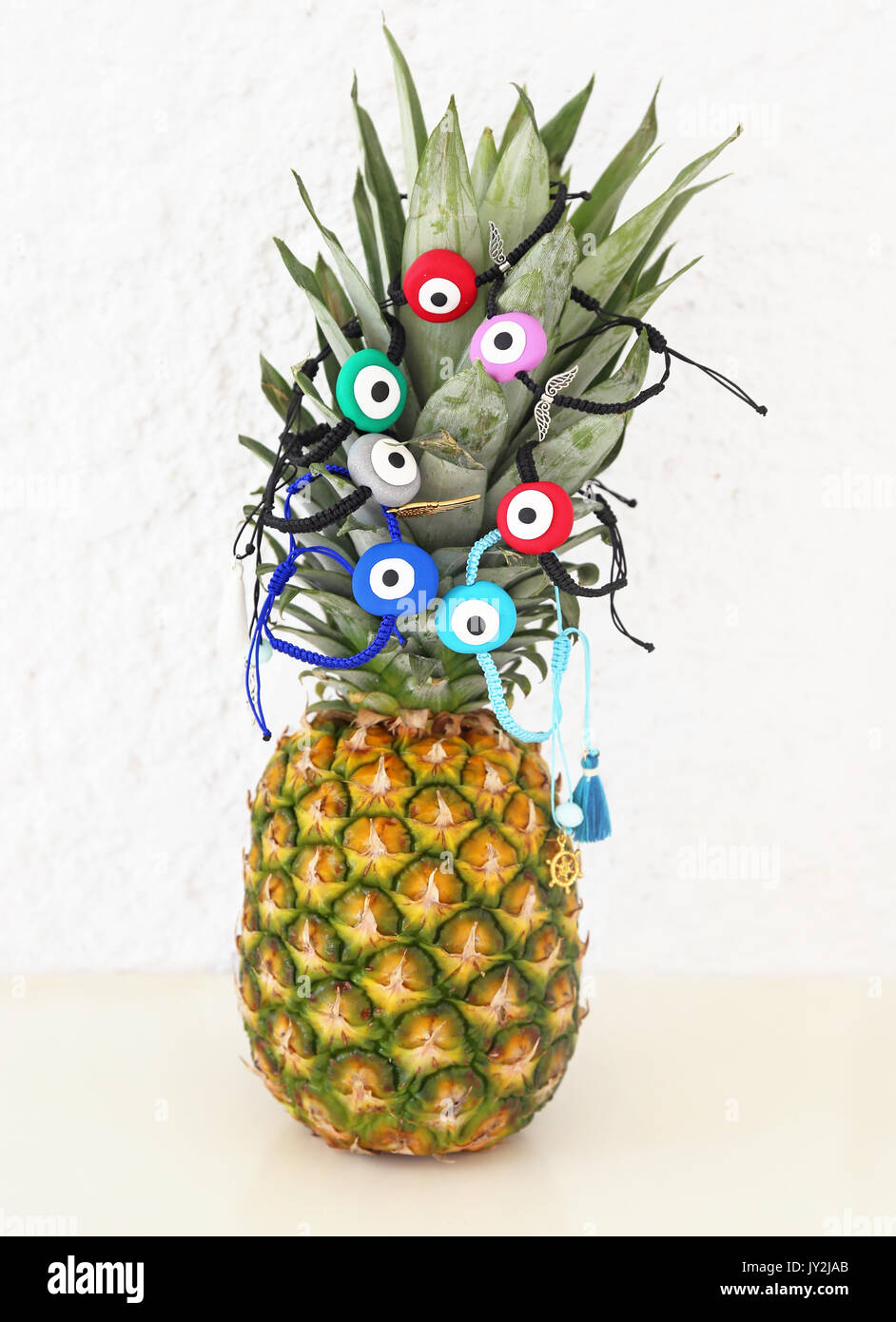 evil eye bracelets advertisement on pineapple - exotic fruit with greek ...