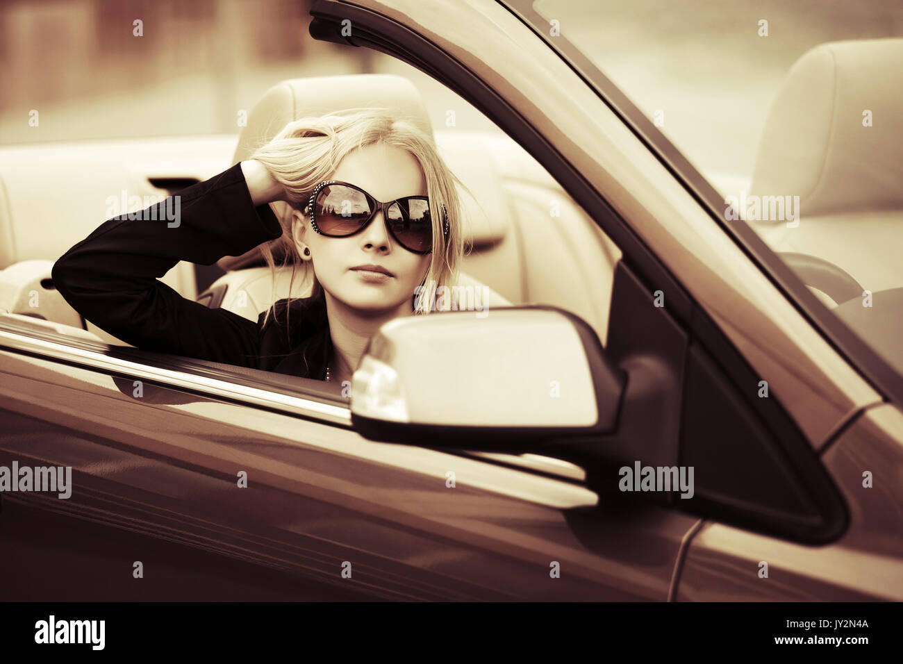 Young fashion woman in a convertible car Stock Photo - Alamy