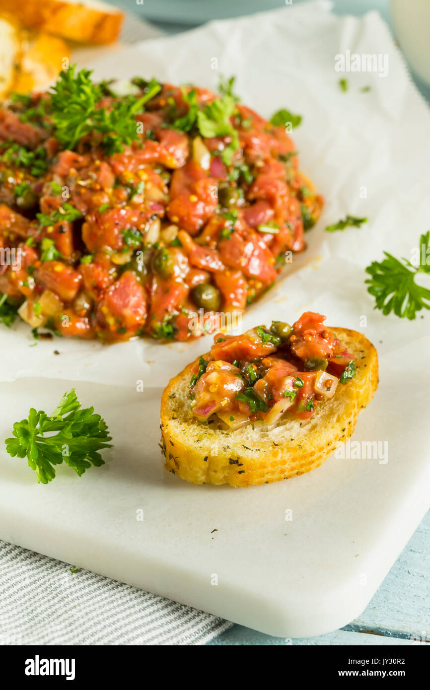Raw Organic French Beef Tartare with Bread Slices Stock Photo - Alamy