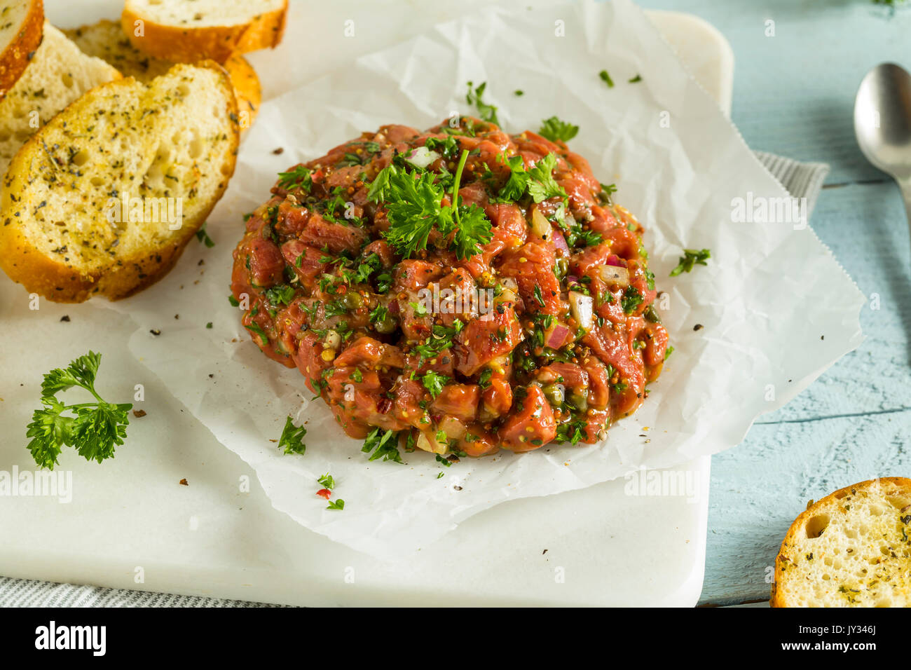 Raw Organic French Beef Tartare with Bread Slices Stock Photo - Alamy
