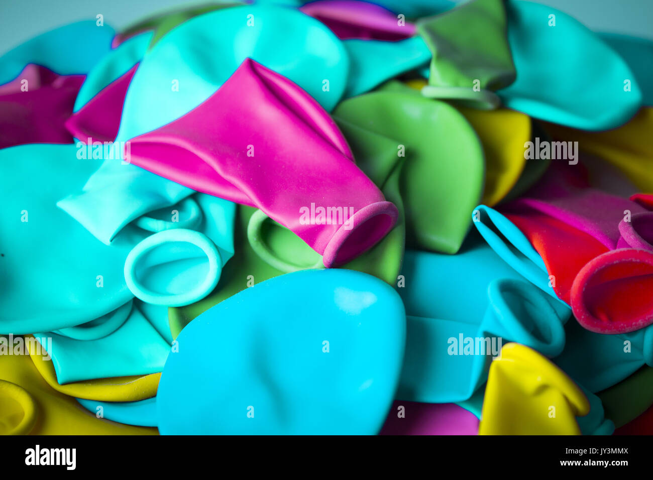 Group of deflated balloons of various colors Stock Photo - Alamy