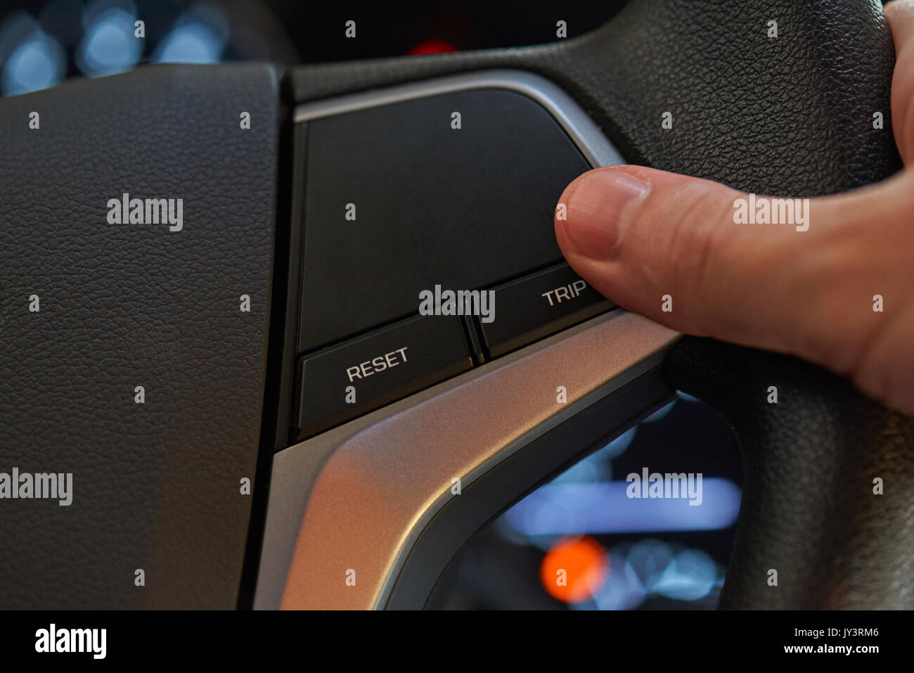Finger press trip button on car wheel close-up Stock Photo - Alamy