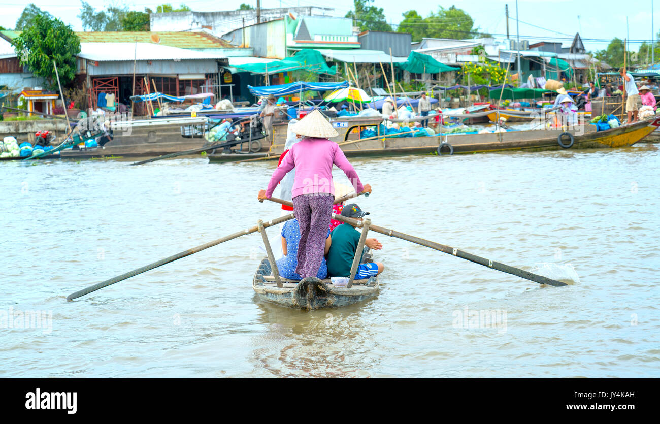 Ferryman rowing takes visitors across river to visit floating market ...