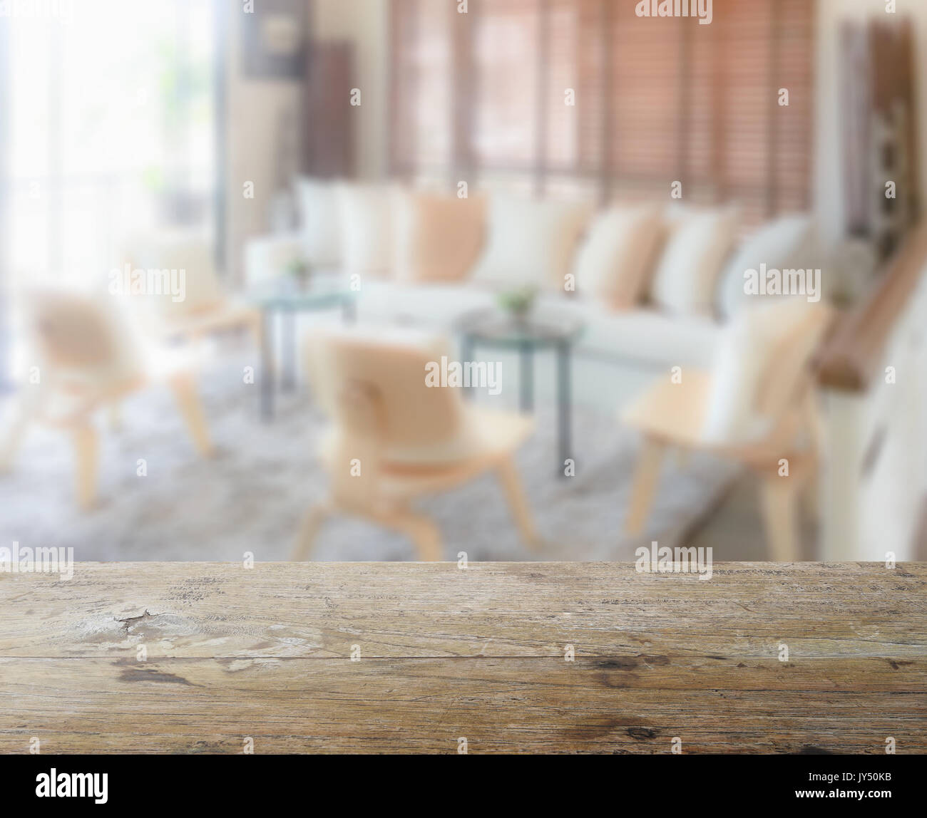 wooden table top with blur of modern living room interior as background ...