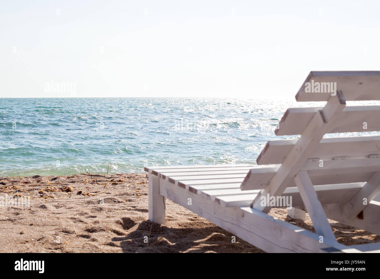 Picture of a white wooden sun chair on the sandy seaside outdoor Stock ...
