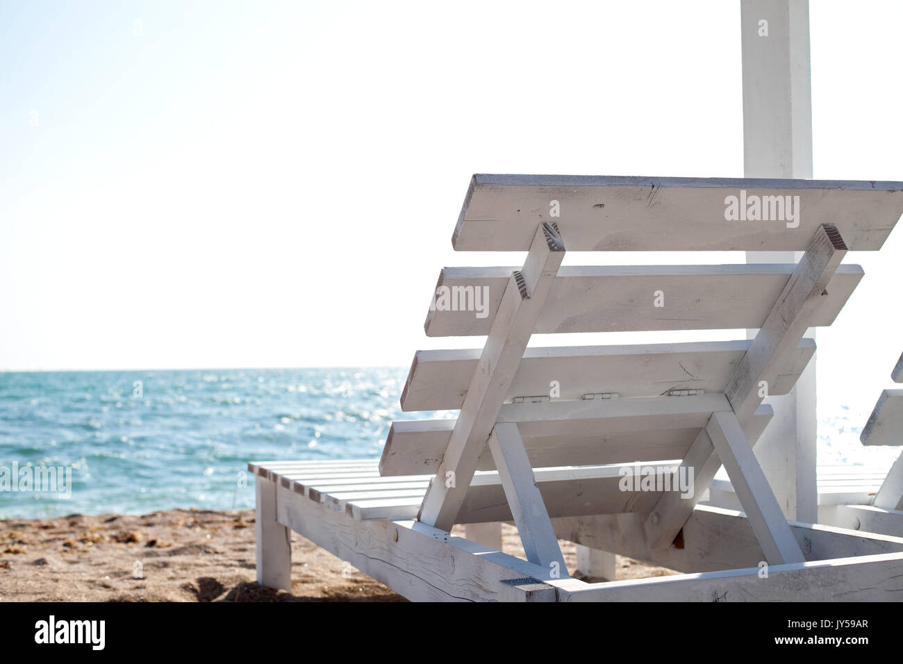 Picture of a white wooden sun chair on the sandy seaside outdoor Stock ...
