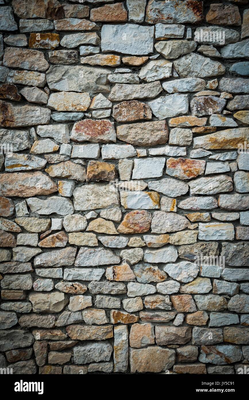Stone wall background of colorful stones. Vignetted borders. Vertical ...