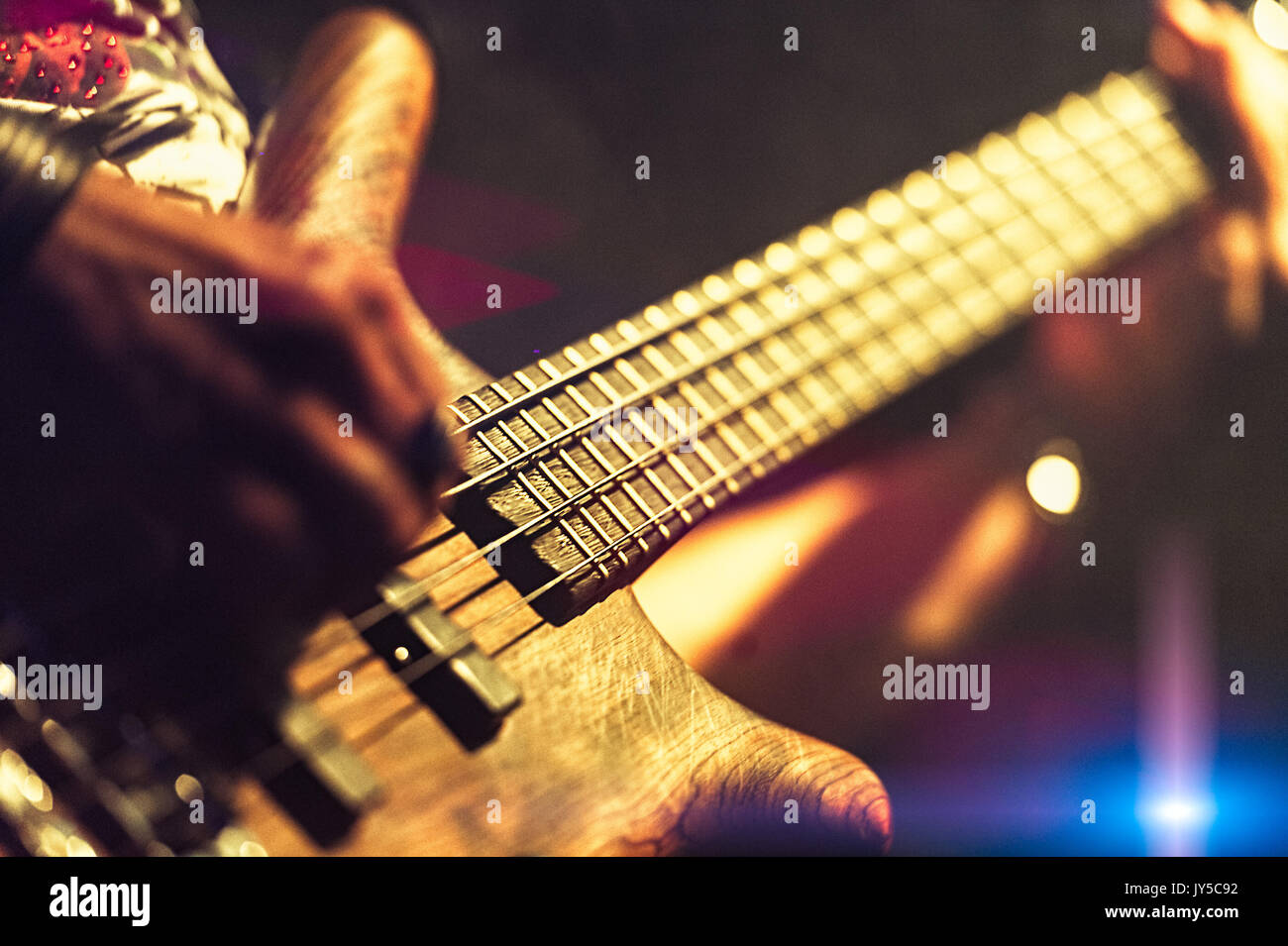 Bassist pop rock during a performance at a concert Stock Photo - Alamy