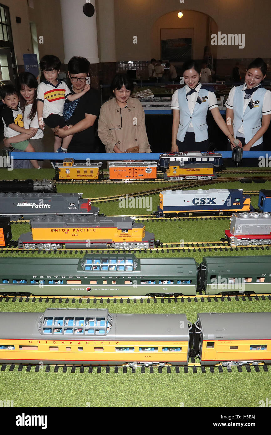 Rail exhibition Visitors look at various train models at a rail ...