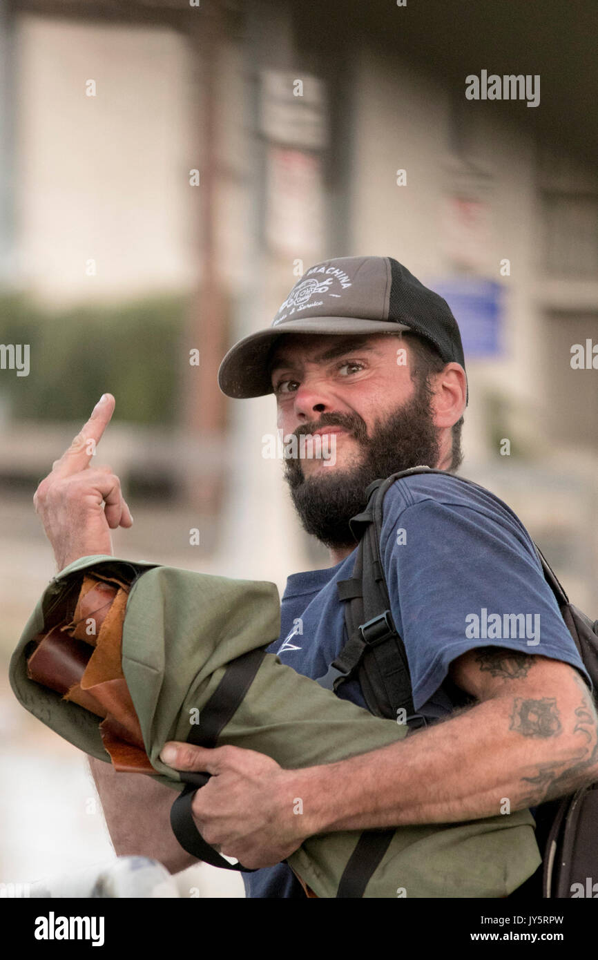 Los Angeles, California, USA. 18th Aug, 2017. A homeless man reacts to ...