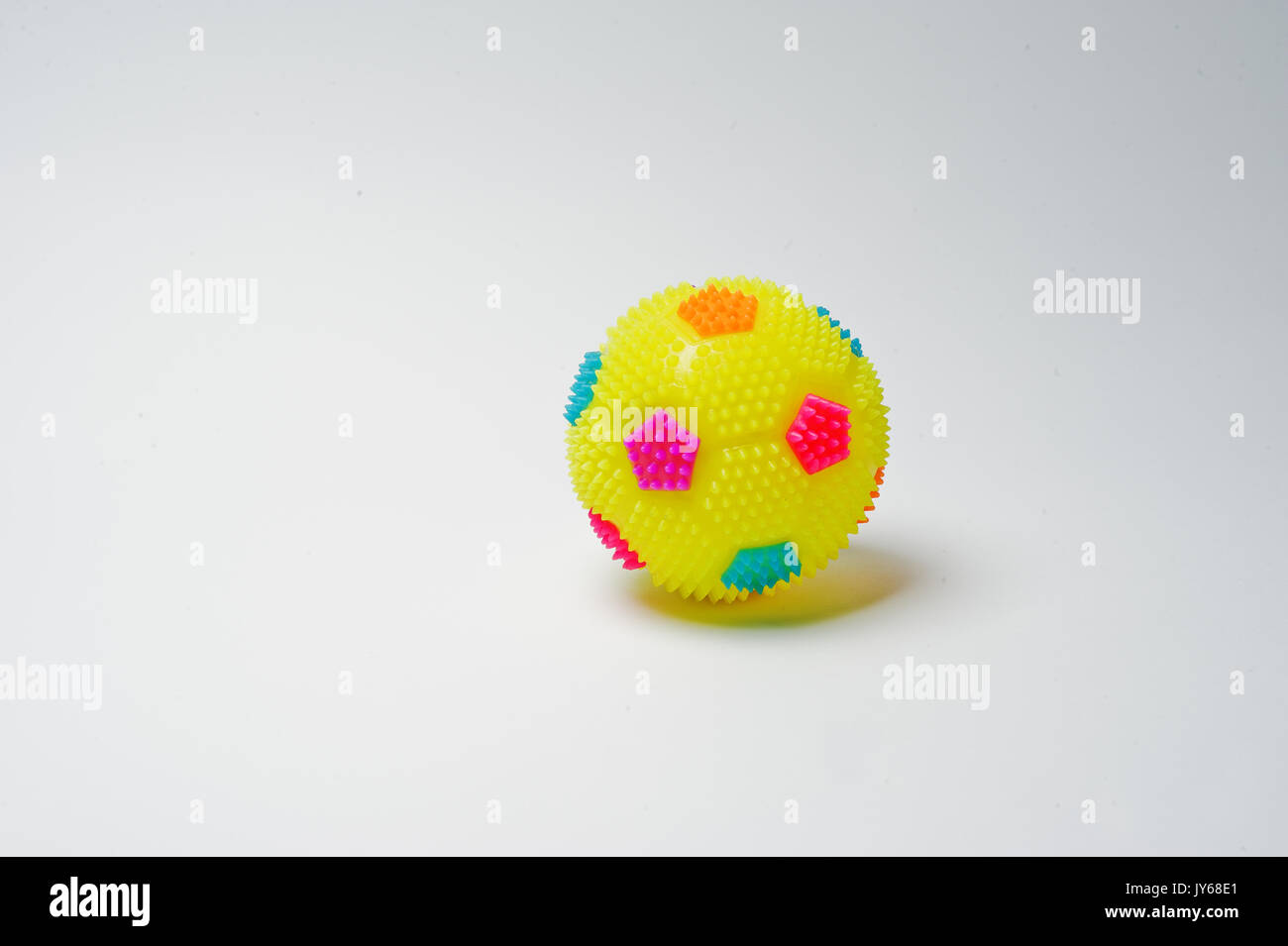 Close-up photo of a small yellow ball on a white background Stock Photo ...