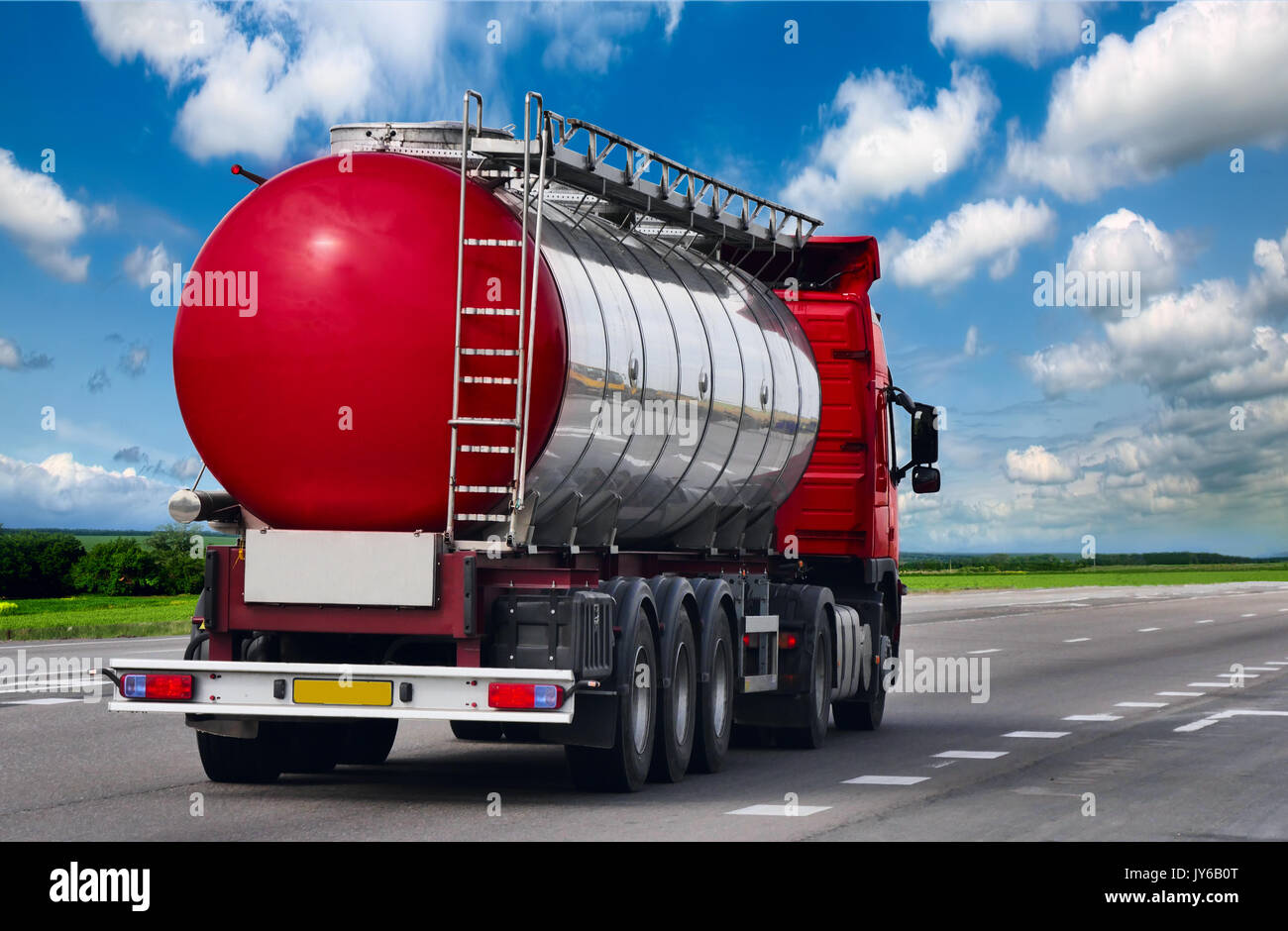 tanker with chrome tanker on a large paved road .. View of the green ...