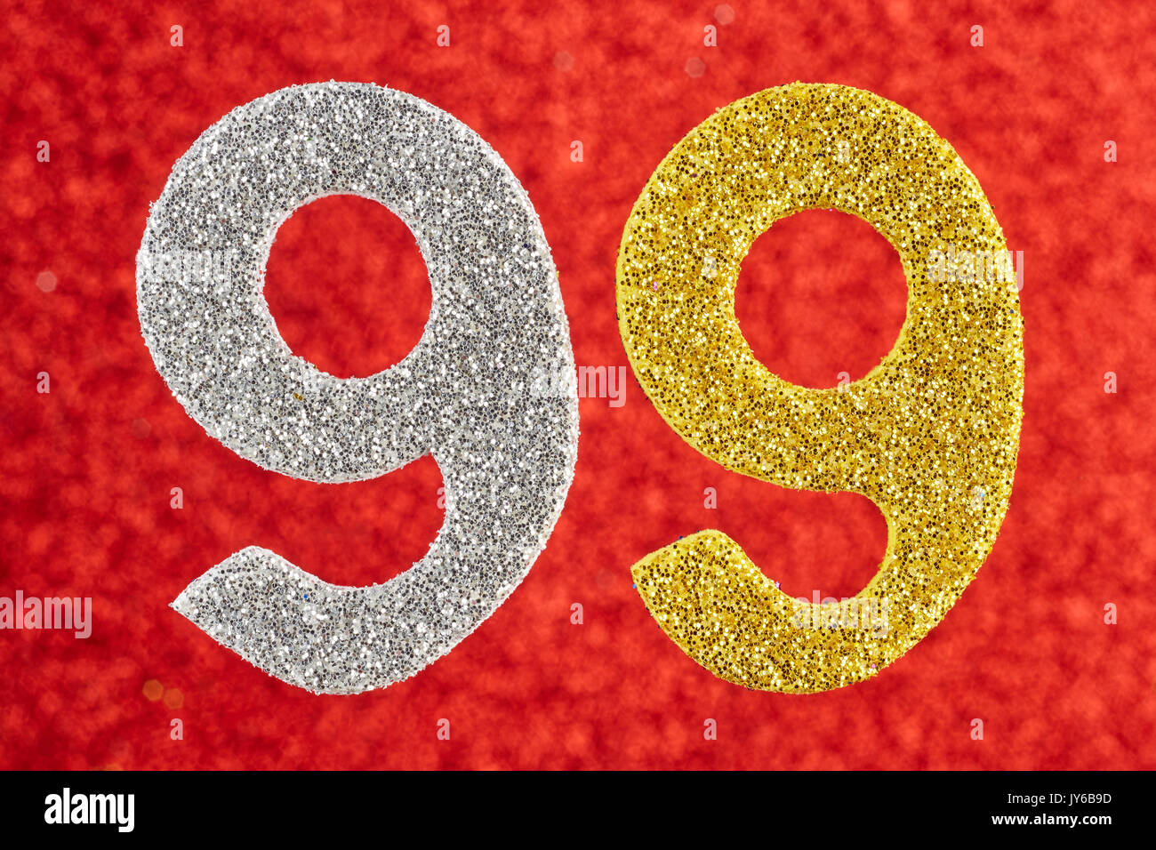 Number ninety-nine silver yellow color over a red background ...