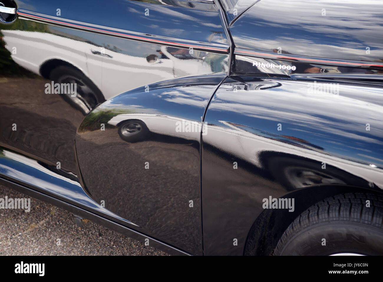 Reflection of a white car in the side of a black Morris Minor 1000 car ...