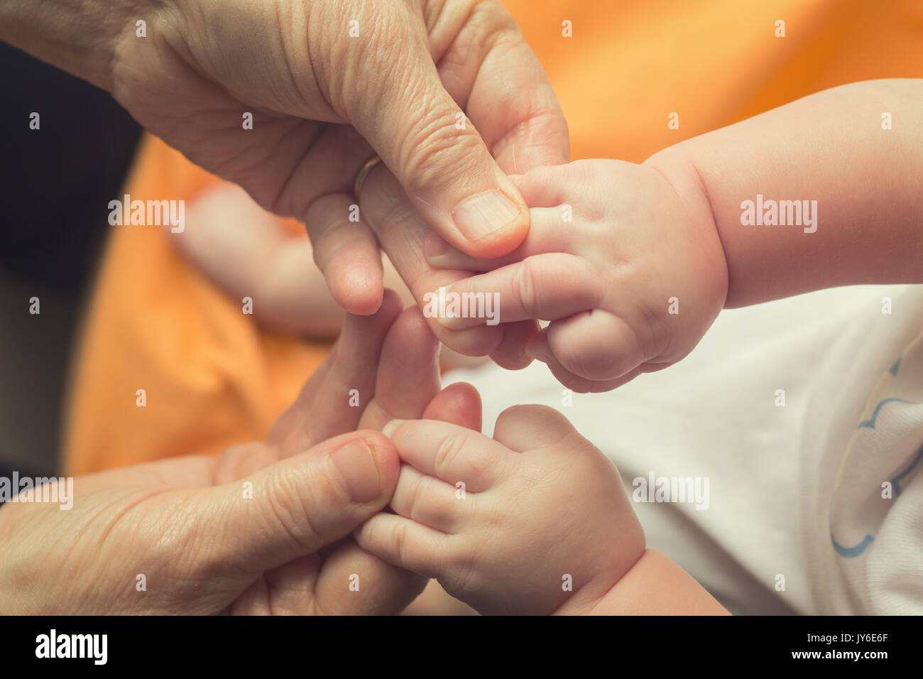 Old baby hands touching hi-res stock photography and images - Alamy