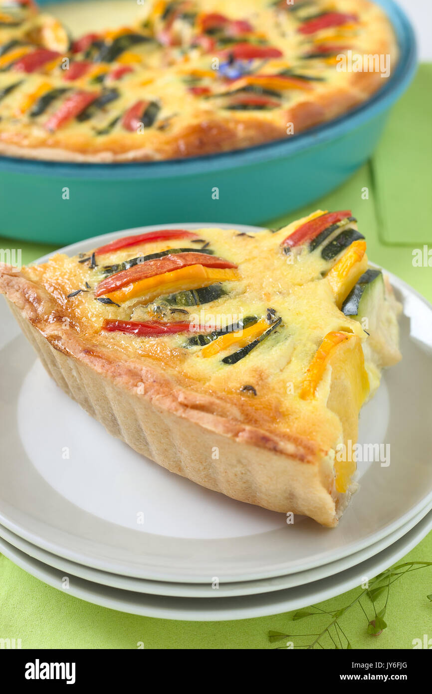 Quiche with tomato, green and yellow zucchini Stock Photo - Alamy