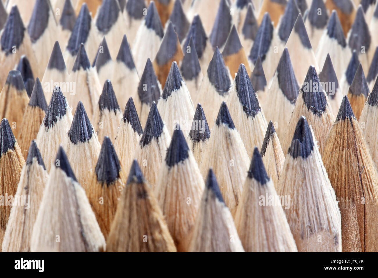 close up of rows of sharp ground graphite wooden texture pencil nibs ...