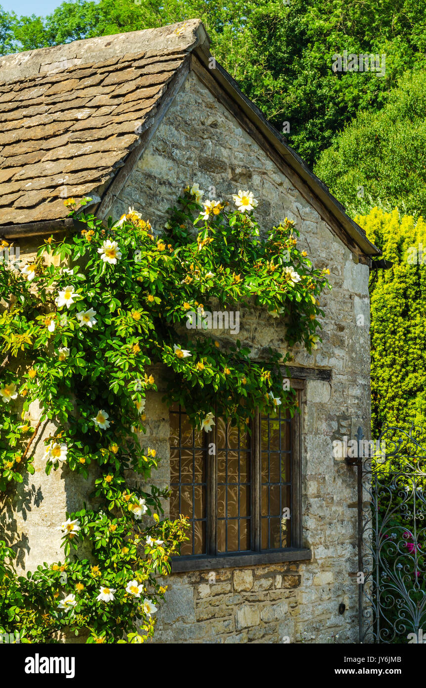 Old wooden window in a historic building, characteristic stone facade ...