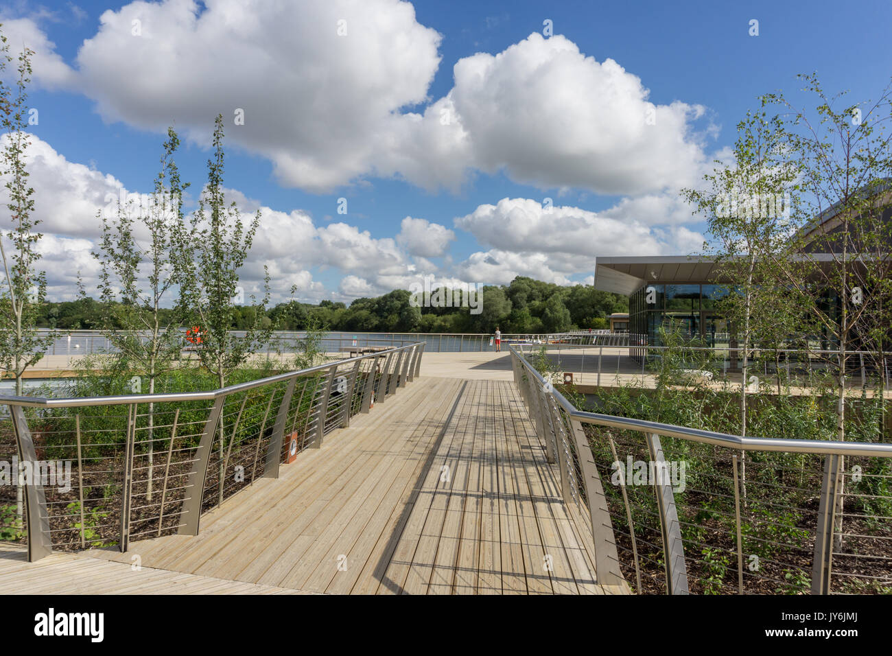 Wooden boardwalk at Rushden Lakes shopping centre with distant views of ...