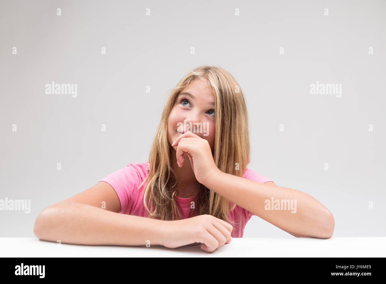 little girl thinking about something possible in the near future ...