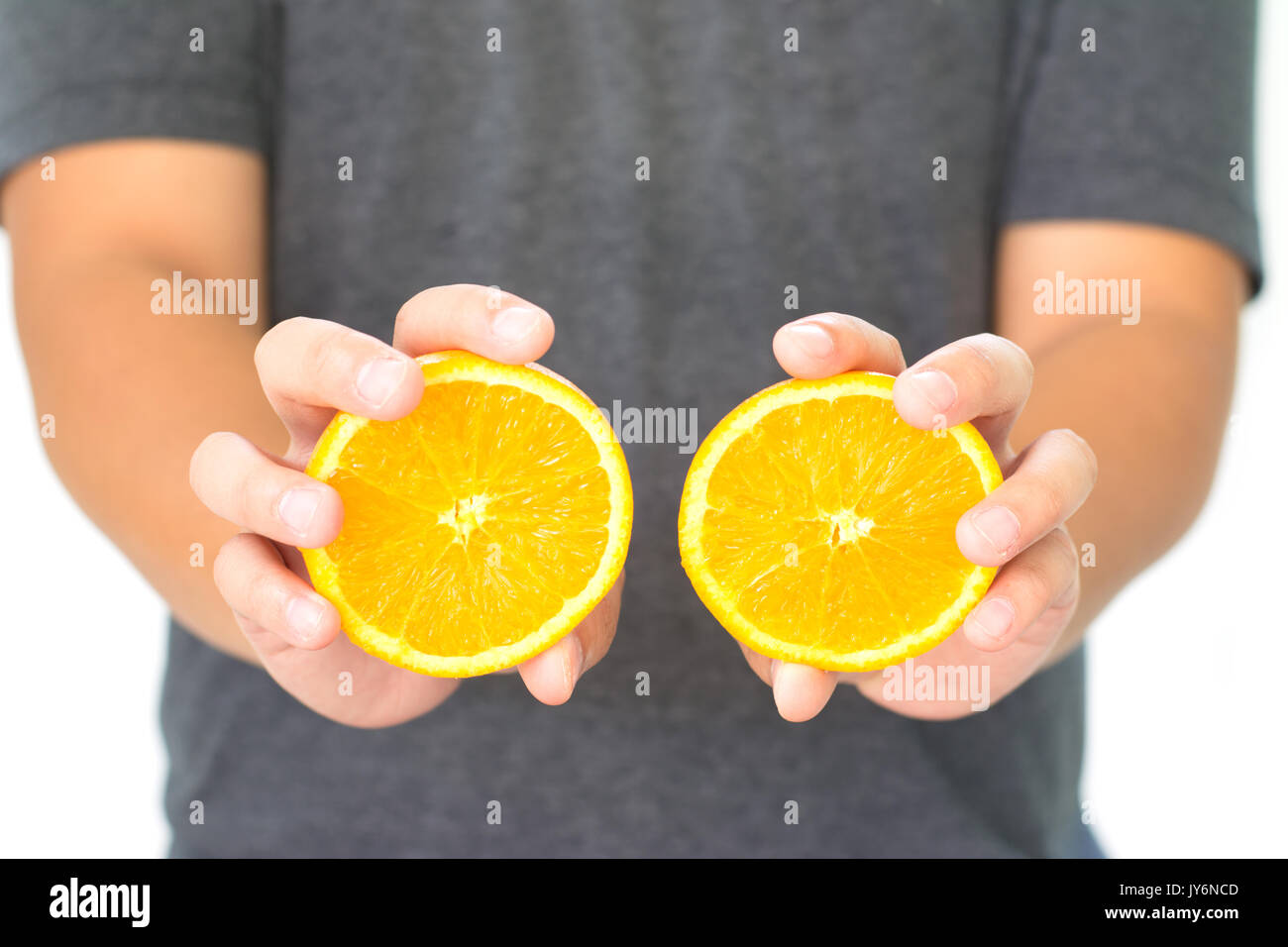 Hand holding orange isolated on white background Stock Photo - Alamy