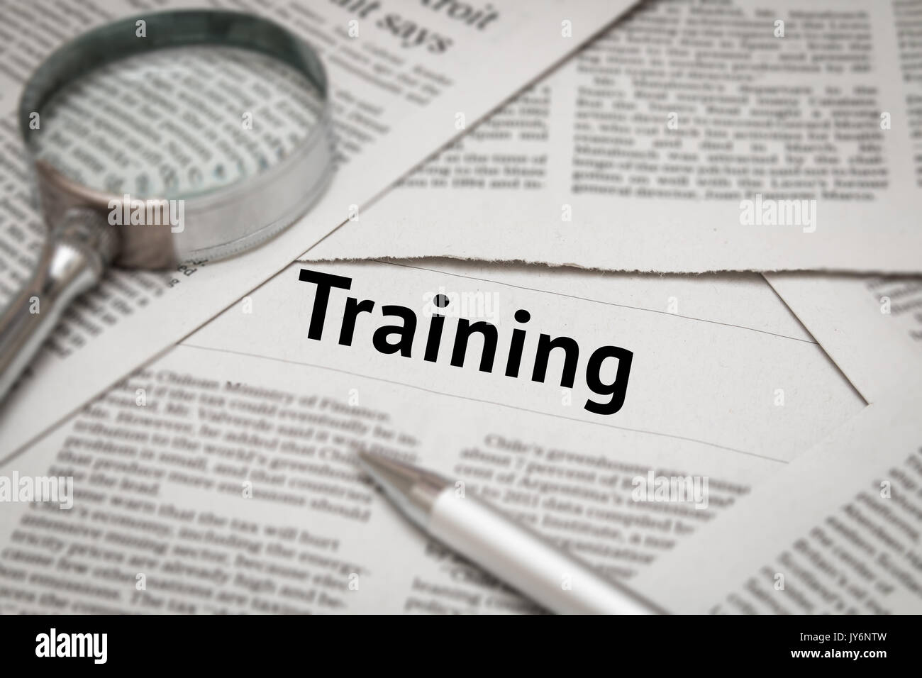 training headline on newspaper background Stock Photo - Alamy