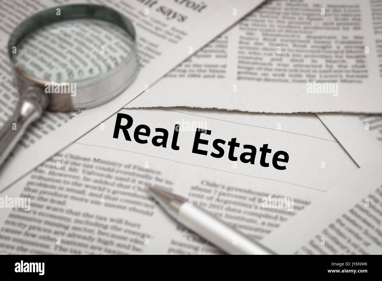 real estate news headline on newspaper Stock Photo - Alamy