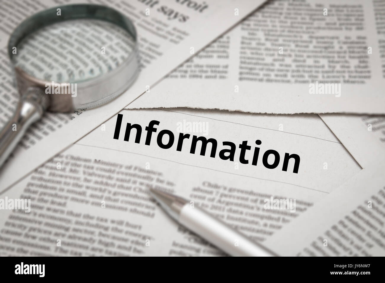 information headline on newspaper background Stock Photo - Alamy
