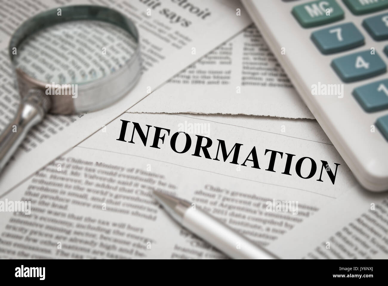 information headline on newspaper background Stock Photo - Alamy