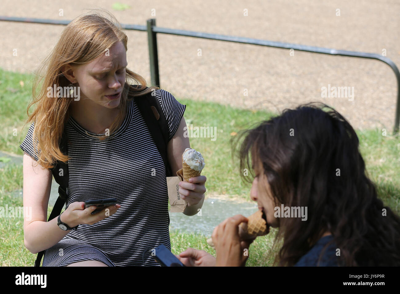 People enjoy the hot weather in St James's Park and Trafalgar Square as ...