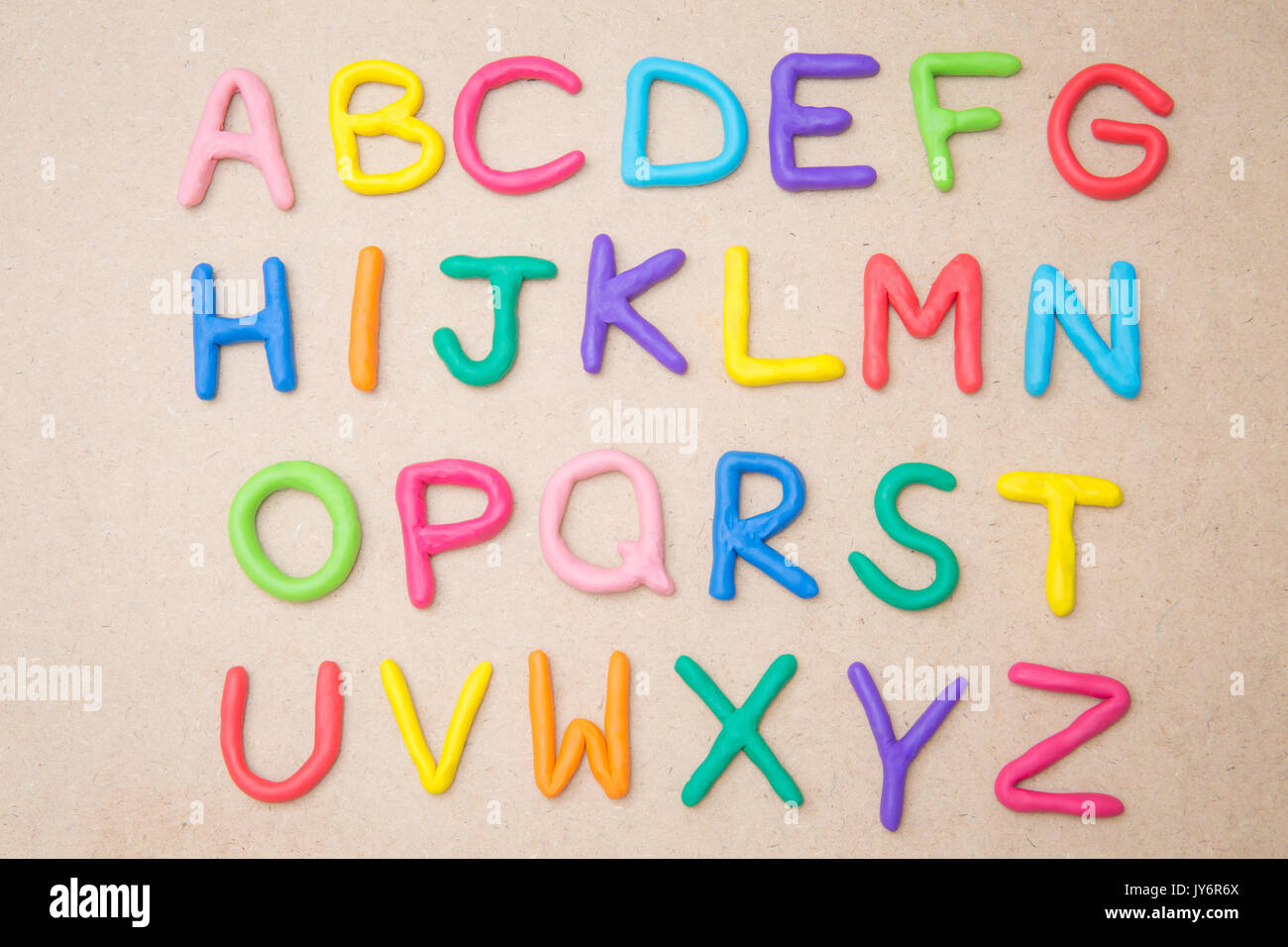 colorful alphabet a to z on brown background Stock Photo - Alamy
