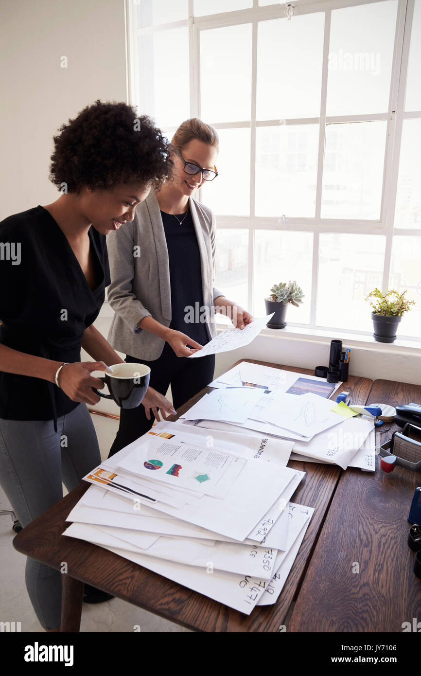 Two happy businesswomen working together in office, vertical Stock ...