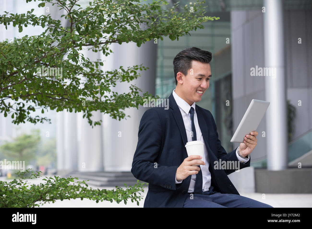 Chinese business man with a tablet computer. Asian business man using ...