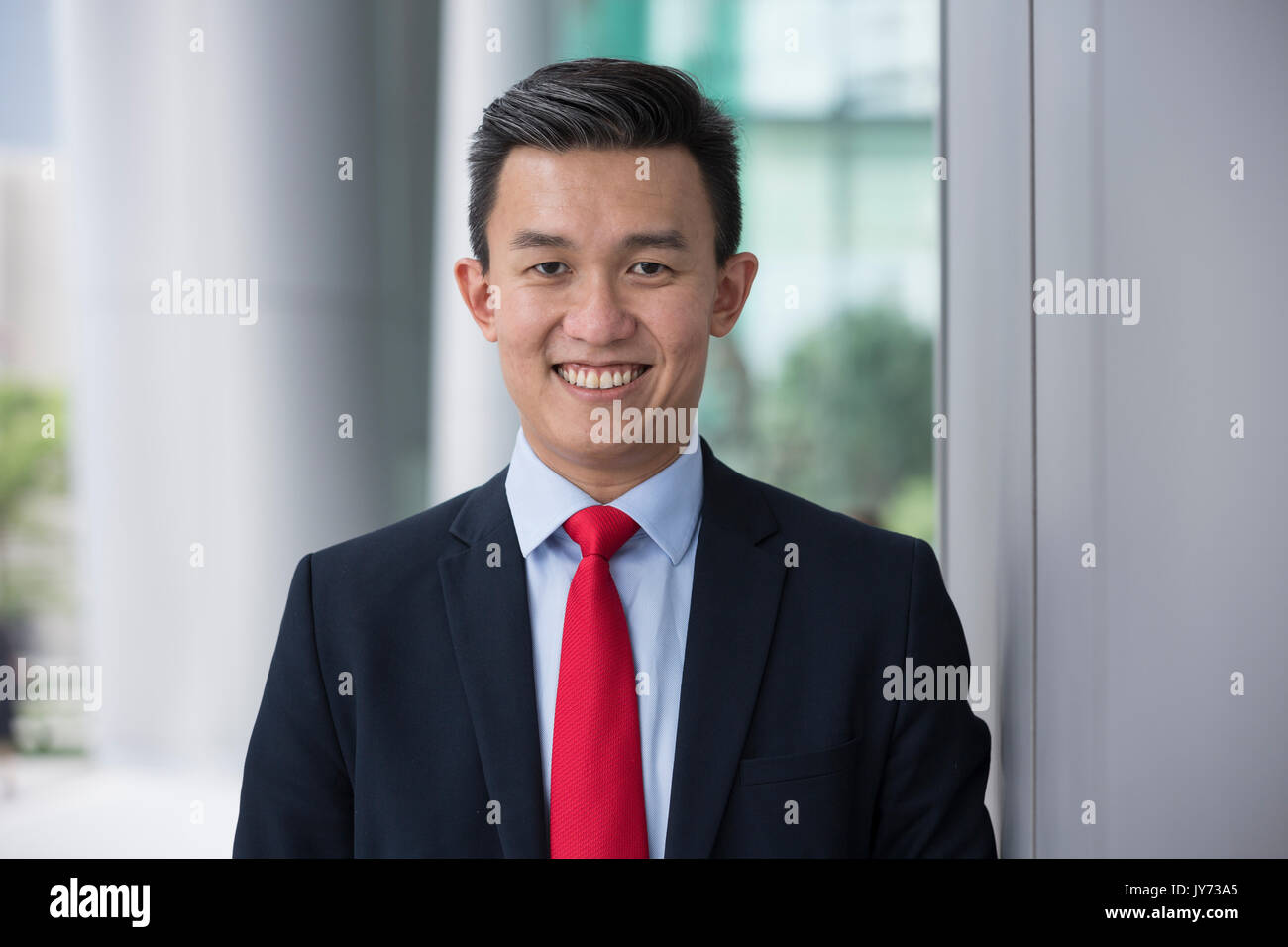 Chinese business man in modern Asian city. Portrait of an Asian ...