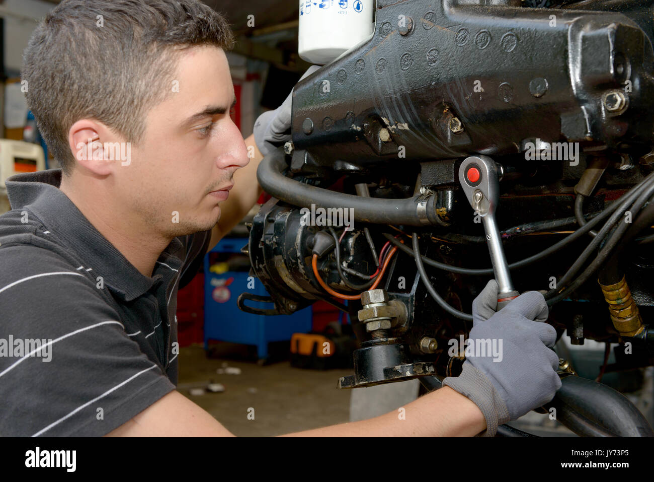 A young man mechanic repairing motor boats and other Stock Photo - Alamy