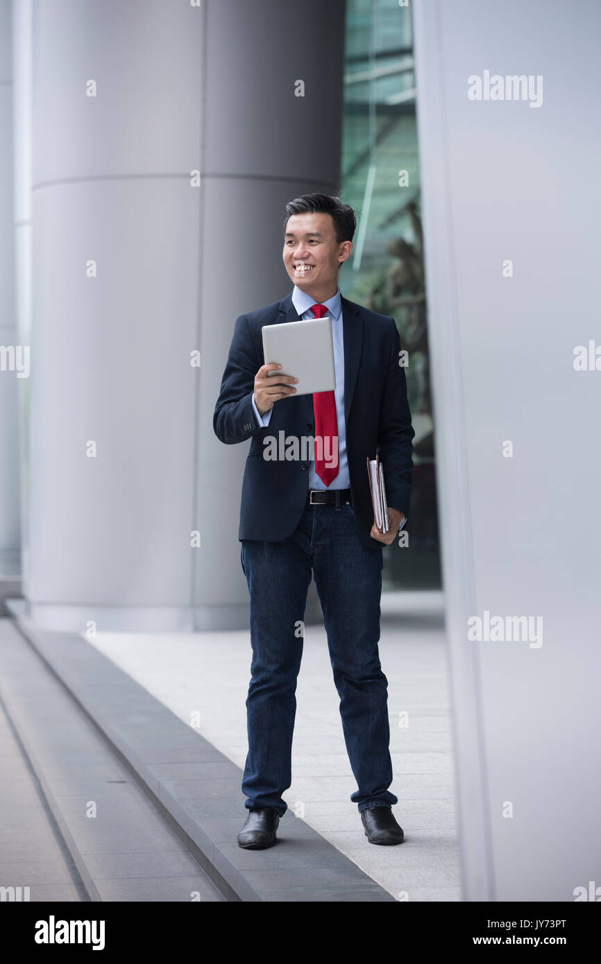 Chinese business man with a tablet computer. Asian business man using ...