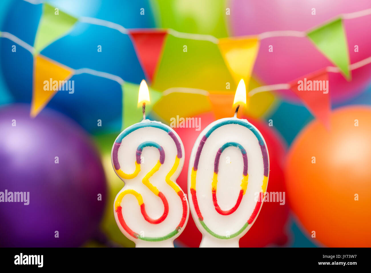 Happy Birthday number 30 celebration candle with colorful balloons and ...