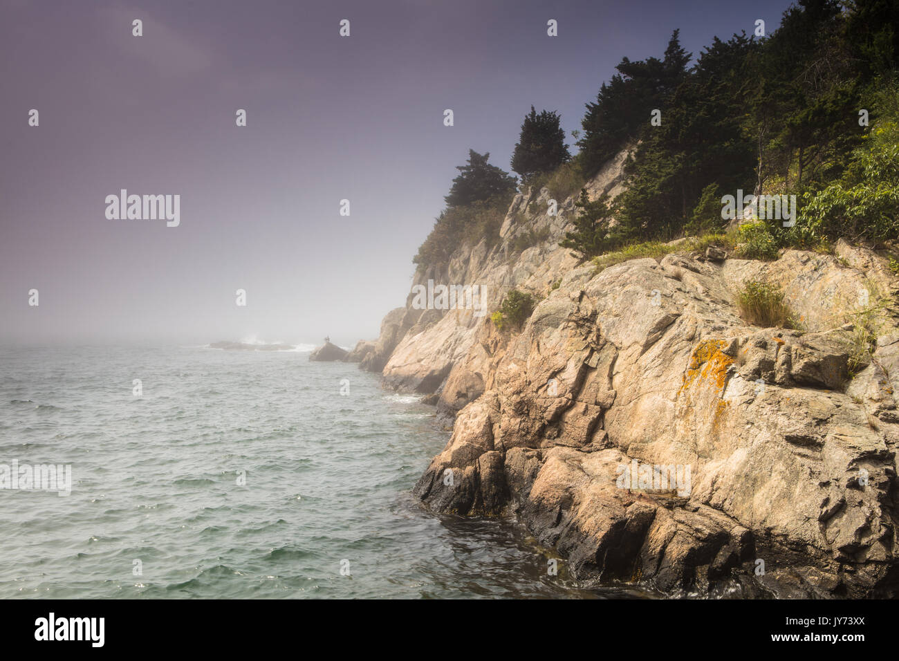 Fog shrouds the rocky cliffs at Fort Wetherill in Jamestown, RI Stock ...