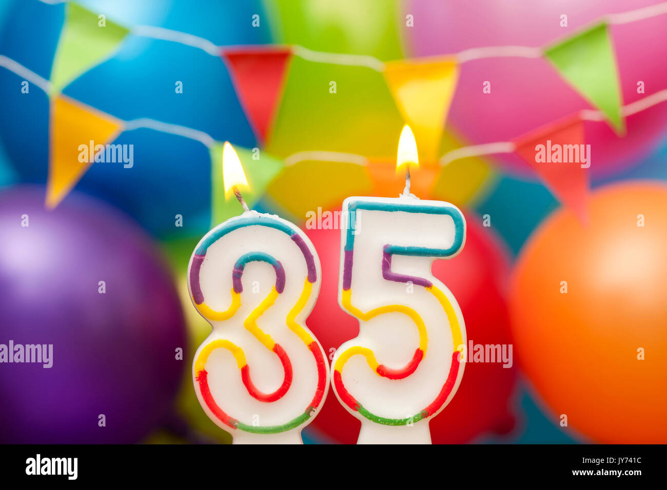 Happy Birthday number 35 celebration candle with colorful balloons and ...