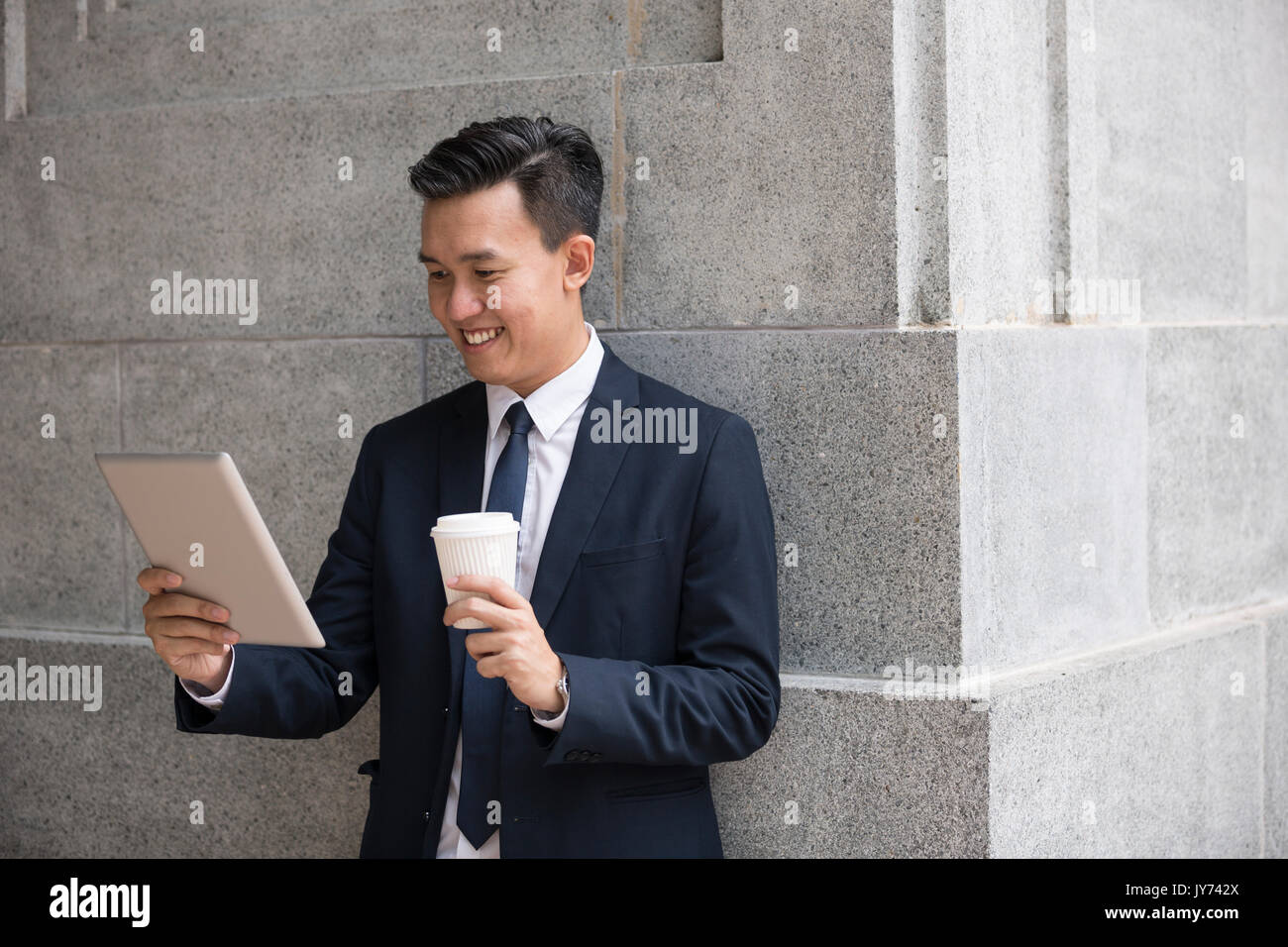 Chinese business man with a tablet computer. Asian business man using ...