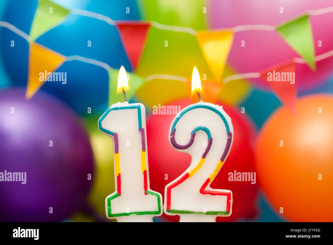 Happy Birthday number 12 celebration candle with colorful balloons and ...