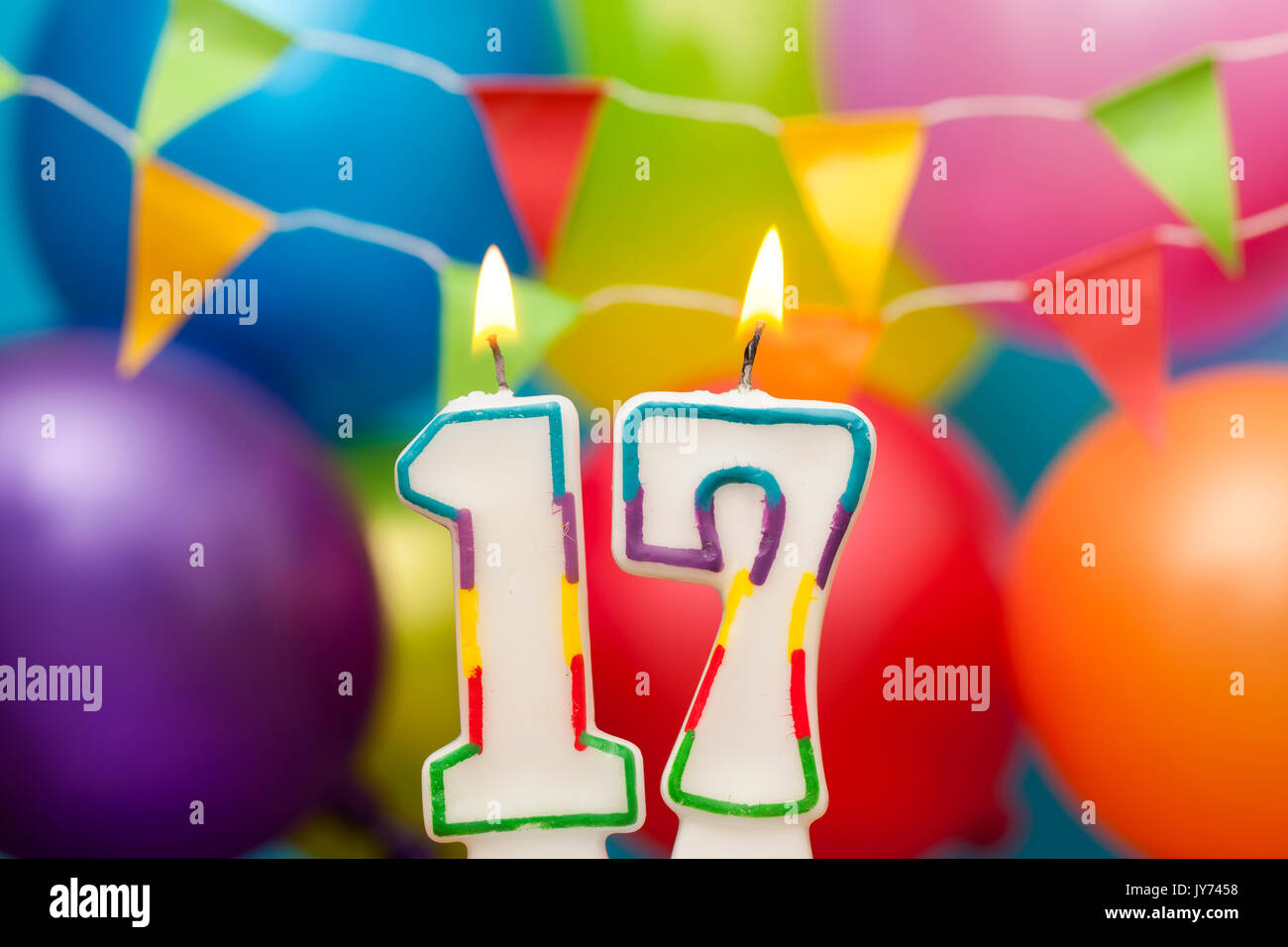 Happy Birthday number 17 celebration candle with colorful balloons and ...