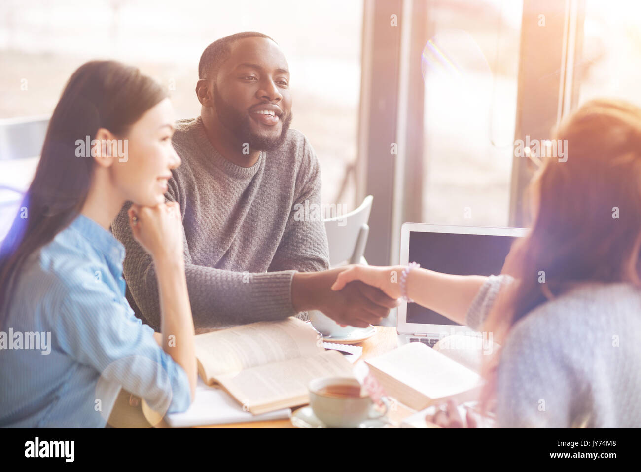 Friends shaking hands asian hi-res stock photography and images - Alamy