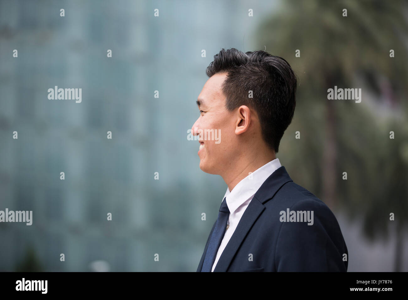 Rear view of an Asian businessman looking away. Chinese business man ...