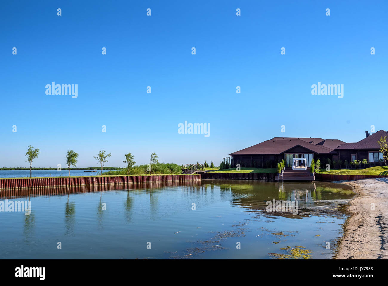 Beautiful view of cottage and pier on river Stock Photo - Alamy