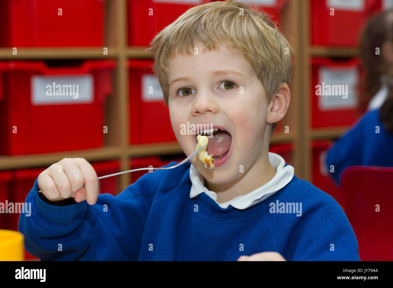 Happy young school child eating lunch at school Stock Photo - Alamy Happy young school child eating lunch at school Stock Photo - Alamy