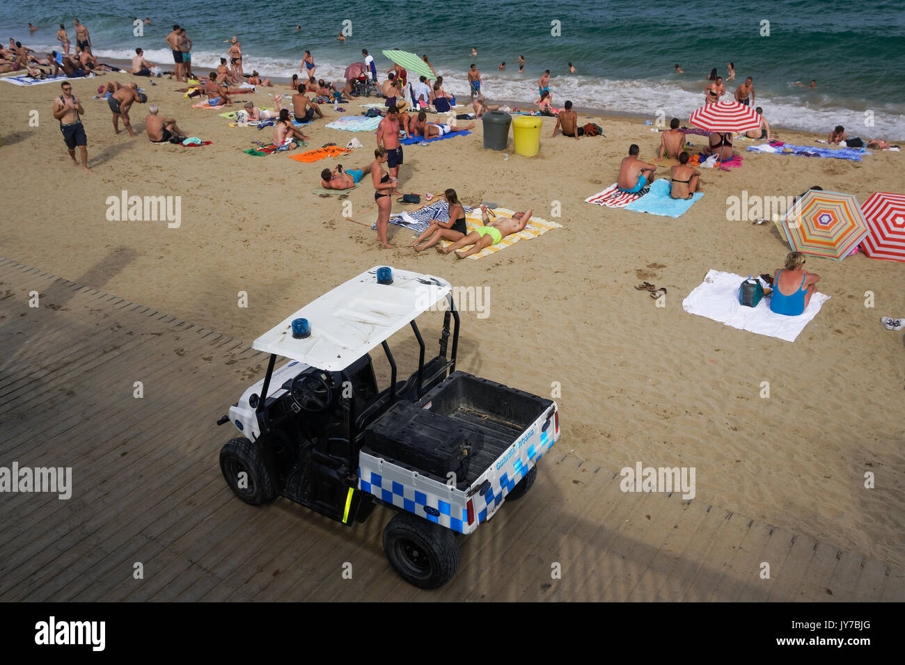 Barcelona Police patrol at Barceloneta beach. Police car securing beach ...
