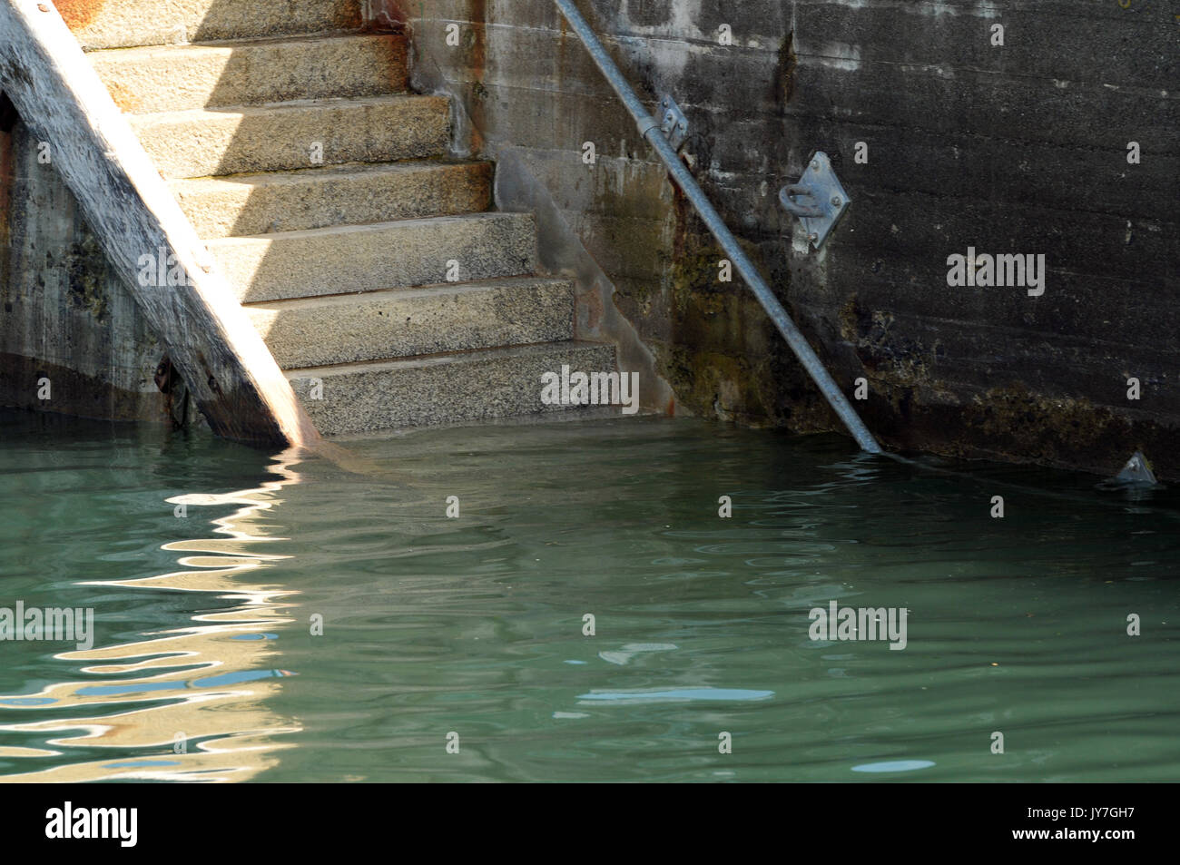a set of stairs or steps going down or up from the water in the harbour ...