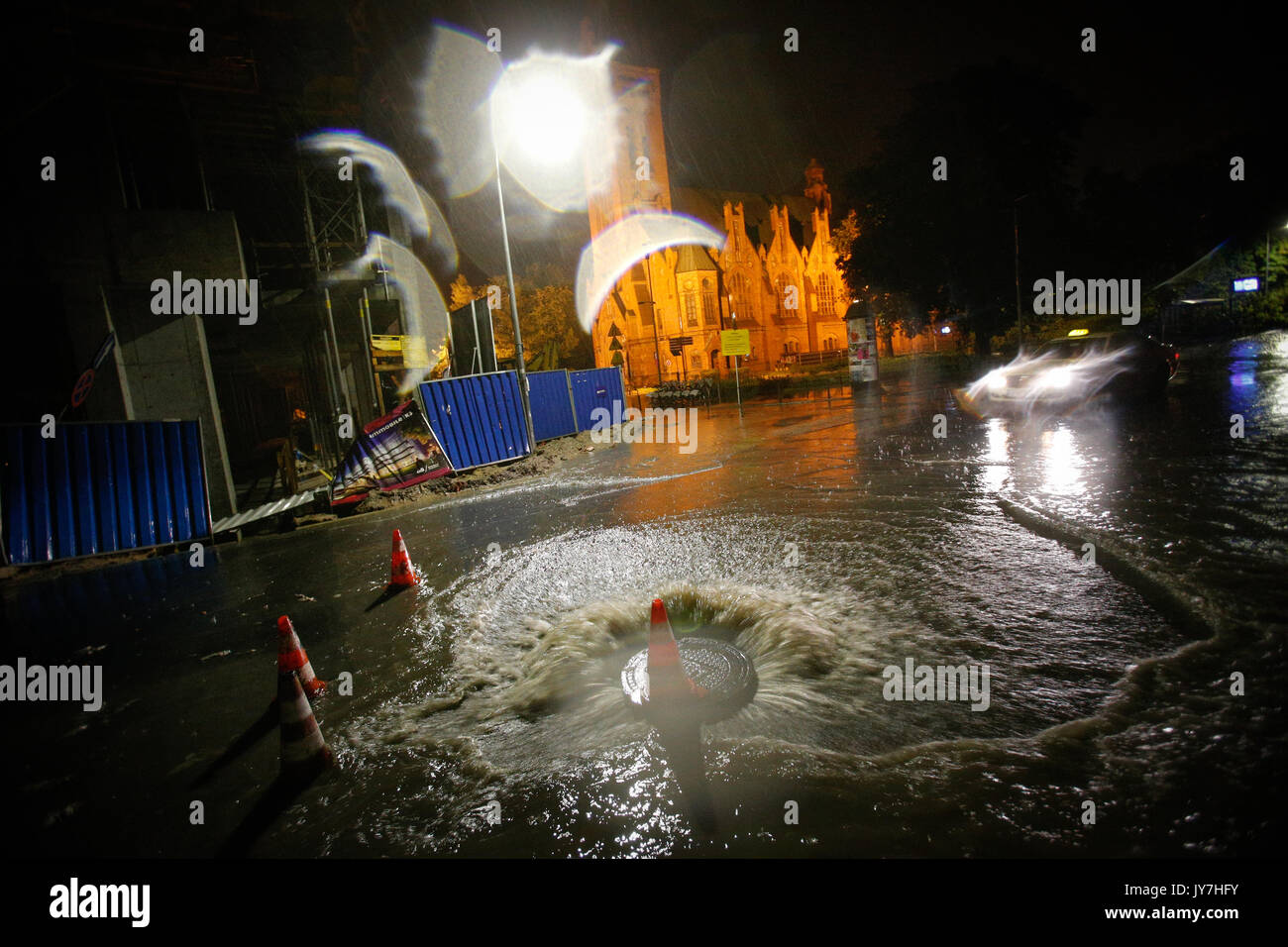 Water from an underground sewage system is seen overflowing onto a ...